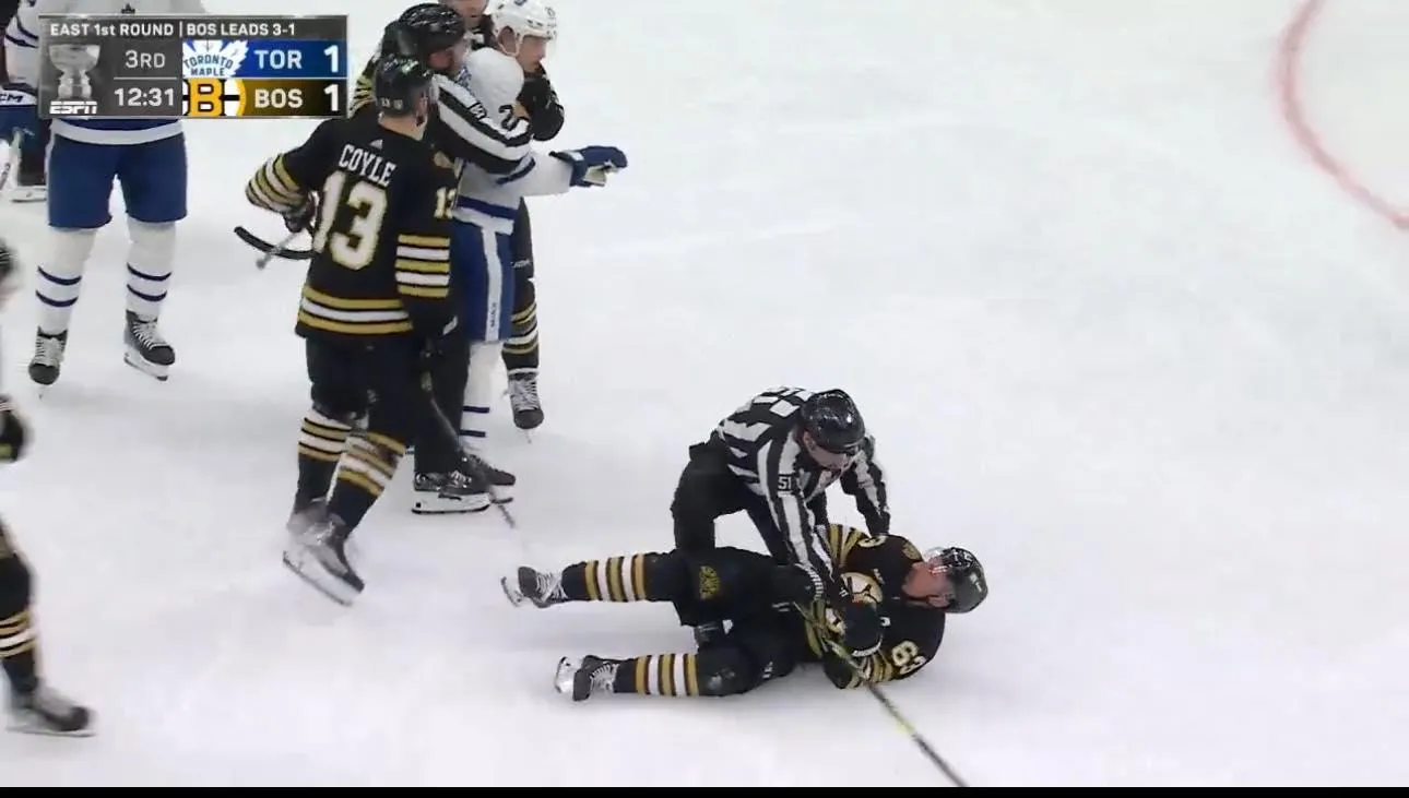 Brad Marchand gets bodied by the ref and falls on the ice